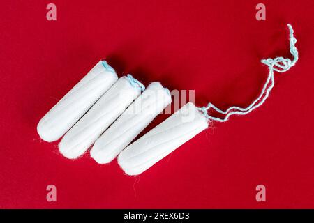 women's sanitary tampon on a red background, sanitary tampon made of ...