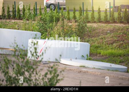 Concrete pipes on the side of the reconstructed road. Large concrete ...