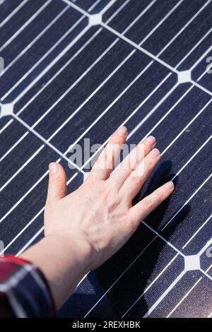Close-up of a hand touching a solar panel Stock Photo - Alamy