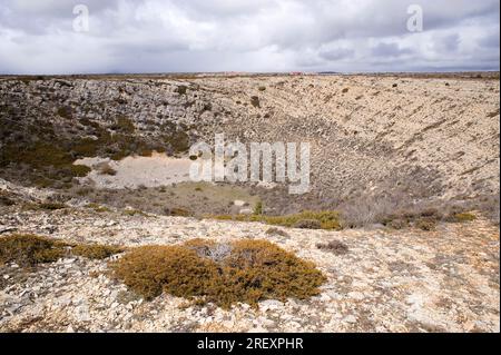 Doline or sinkhole is a hole in the ground caused by a karstic proces ...