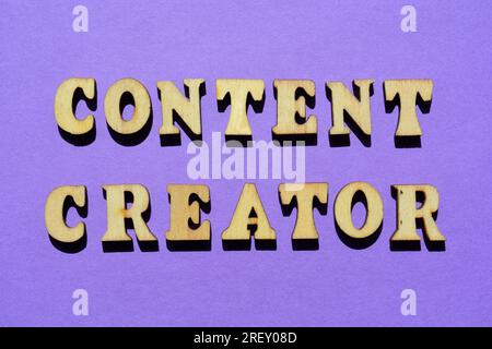 Content Creator, words in wooden alphabet letters isolated on yellow ...