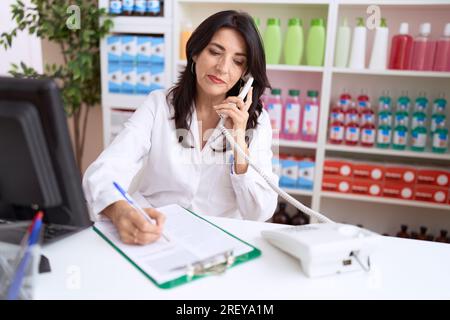 Middle age hispanic woman pharmacist smiling confident standing with ...