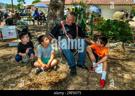 A Native American boy member of the Acjachemen tribe plays the clapper ...
