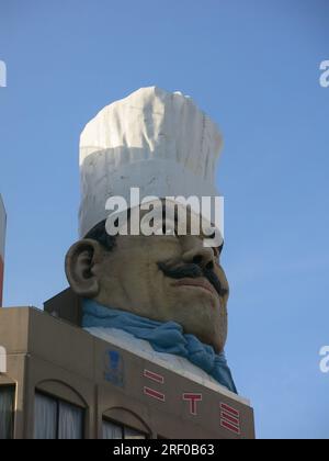 Giant model of a chef in a chef's hat on the top of a building on ...