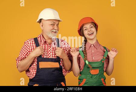 glad teen child in builder hard hat with paint roller and spatula on ...