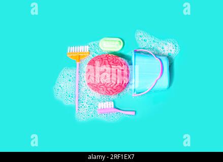 Washing a toy human brain with essential home cleaning tools arranged ...