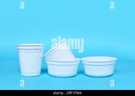 Different plastic waste packages on blue background Stock Photo - Alamy
