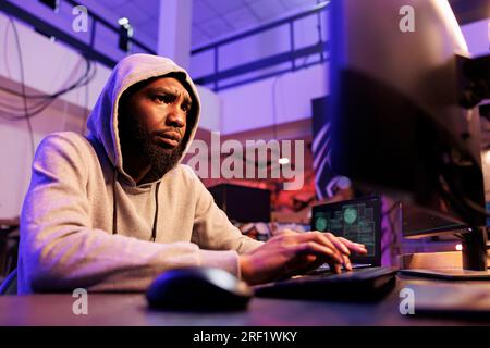 African american hacker breaching database with holograms Stock Photo ...