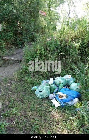 Wild garbage dump in nature. Open landfill site. Pile of garbage ...