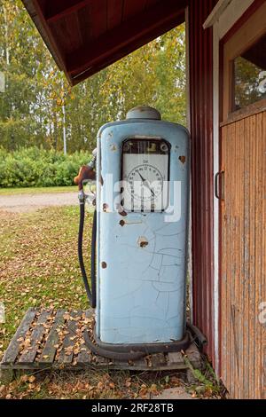 Old vintage gas pump against a wooden wall Stock Photo - Alamy
