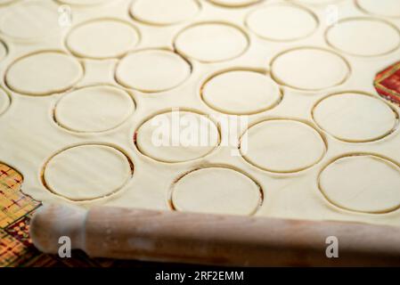 Dough with sliced circles for making variants. Food background. Dough ...