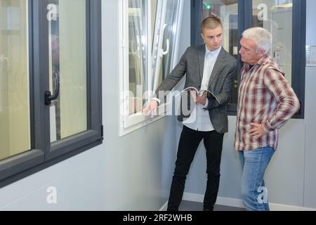 salesman showing double glazed windows to customer Stock Photo - Alamy