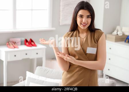 beautiful shop assistant with shoe in a boutique Stock Photo - Alamy