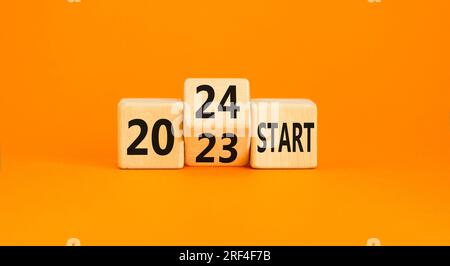 2024 restart new year symbol. Businessman turns a wooden cube and ...