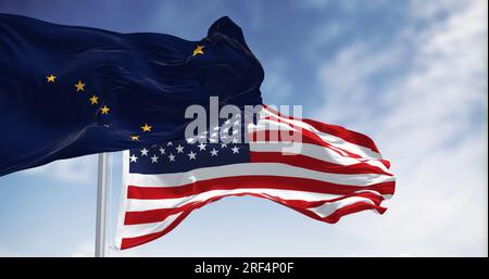 Alaska state flag waving in the wind with the national flag of the ...