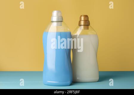 Bottles of fabric softener on light blue table, space for text Stock ...