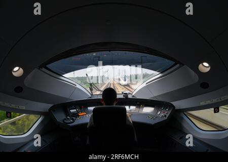 High-speed train. Driver operating a train on the new fast line between ...