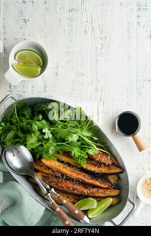Appetizing grilled eggplant slices with spices on white plate. Fresh ...
