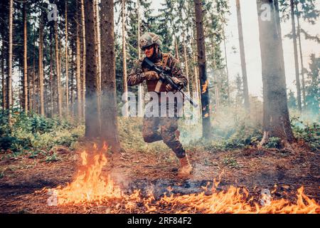 Modern warfare soldier surrounded by fire, fight in dense and dangerous ...