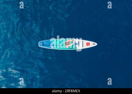 June 21, 2022. Dalaman, Turkey. Woman on stand up paddle board at blue ...