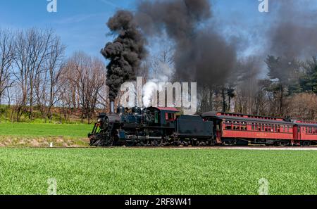 Angled View of a Restored Steam Passenger Train Moving Slowly Blowing ...