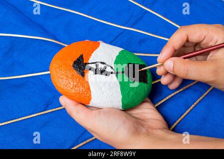 Hand painting stone with brush . Indian flag color with " amar Jawan ...