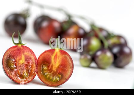 Bunch of yoom tomatoes on white background Stock Photo - Alamy