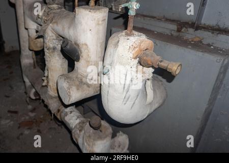 Photo of pipe insulation containing asbestos fiber in a mechanical room ...