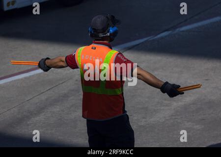Runway signaling worker is seen at the Dallas-Fort Worth International ...