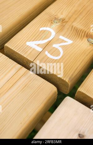 Numbers painted oon wooden benches in a pub garden in the UK to ...