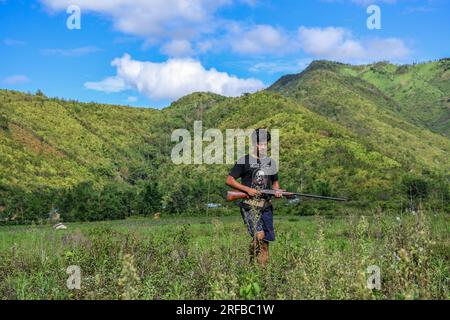 An armed Kuki man, walks as he guards a village in Churachandpur ...