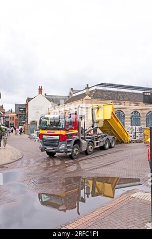 Lindum Waste lorry collecting full builders skip from building site ...