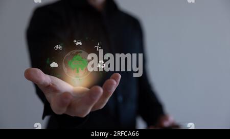 Hand holding virtual Global with CO2 reducing icon for concept of decrease carbon dioxide ...