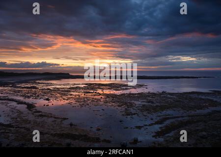 Sunset over Coves Haven Holy Island Stock Photo - Alamy