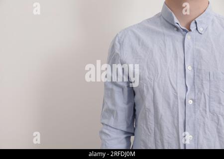 Man wearing rumpled shirt on white background, back view Stock Photo ...