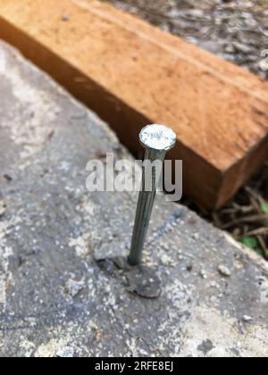 Concrete nails that are driven into the cement floor to tie ropes that ...