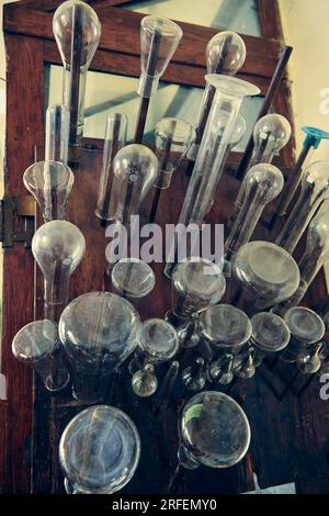 Glass bottles, test tubes, flasks and cups in an old chemical ...