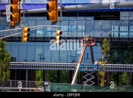 Workers are installing glass panels on wooden frames at construction ...