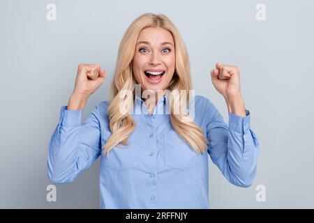 Photo of delighted overjoyed girl raise fists celebrate triumph luck ...