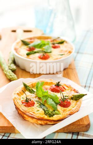 mini quiche witn tomato cherry and green asparagus Stock Photo - Alamy