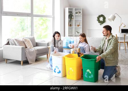 Family sorting garbage in recycle bins at home Stock Photo - Alamy