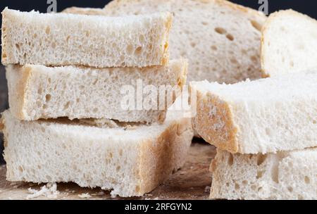sliced pieces of gray bread from second rate low quality flour, bread ...