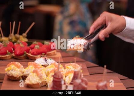 hand holding a traditional basque appetizer Stock Photo - Alamy