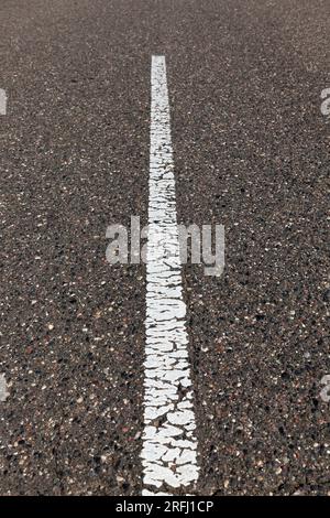 paved road with white road markings, painted with white paint ...