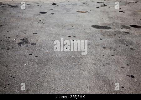 car oil stains on an asphalt road, stains from engine oil flowing out ...