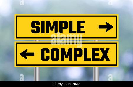 Simple or complex road sign on blue sky background Stock Photo - Alamy
