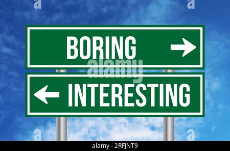 Boring or interesting road sign on blur background Stock Photo - Alamy