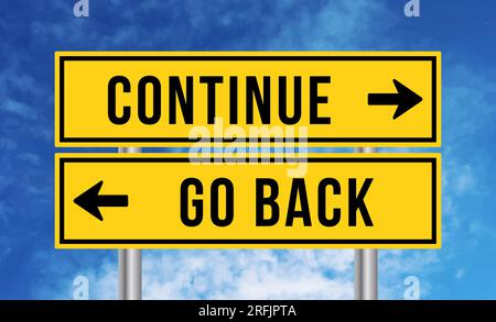 Continue or go back road sign on blur background Stock Photo - Alamy