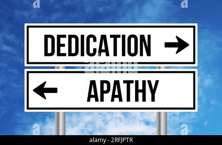 Dedication or apathy road sign on cloudy sky background Stock Photo - Alamy