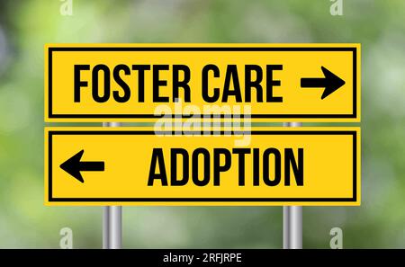 Adoption road sign on blur background Stock Photo - Alamy